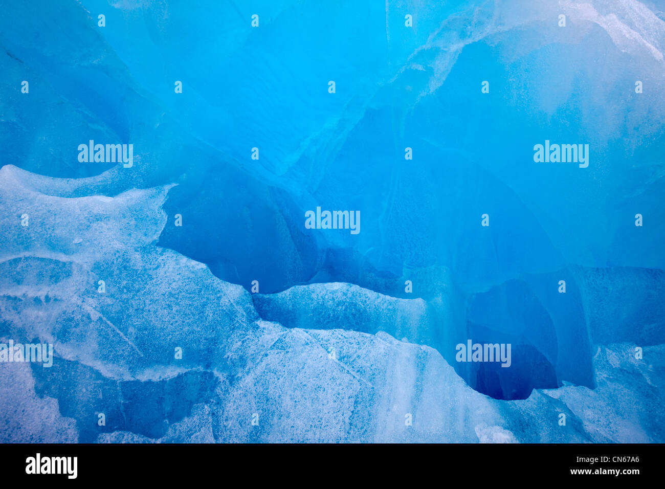 Norway Svalbard Spitsbergen Deep blue iceberg floating near face of ...