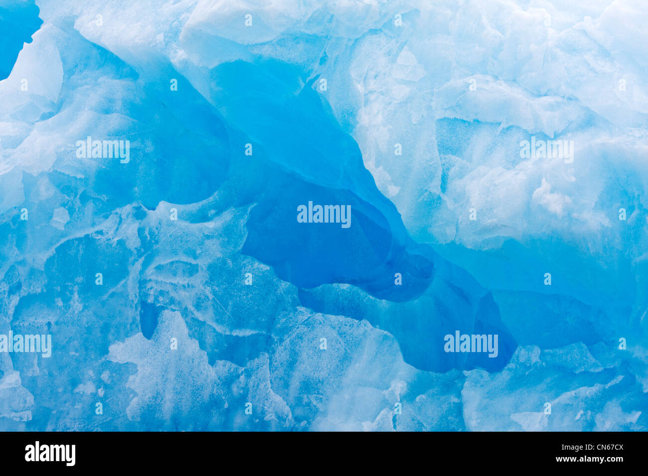 Norway Svalbard Spitsbergen Deep blue iceberg floating near face of ...