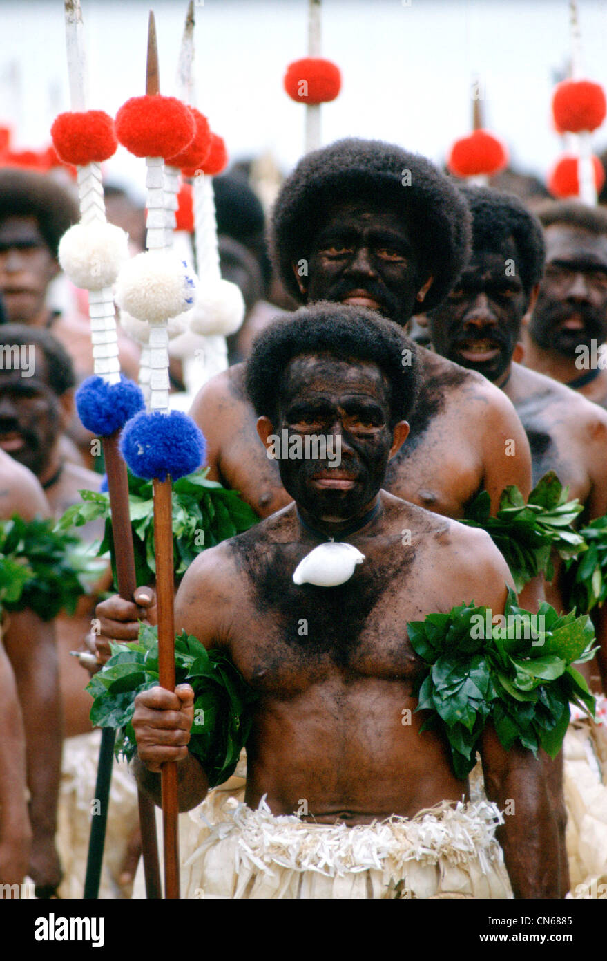 Fijian warriors faces painted black in the traditional manner while ...