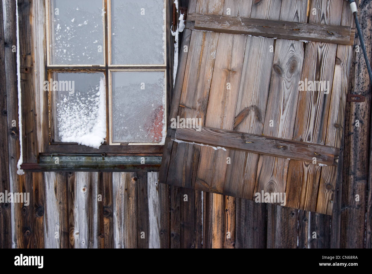 Norway Svalbard Nordaustlandet Window of wooden trapper’s hut in storm ...
