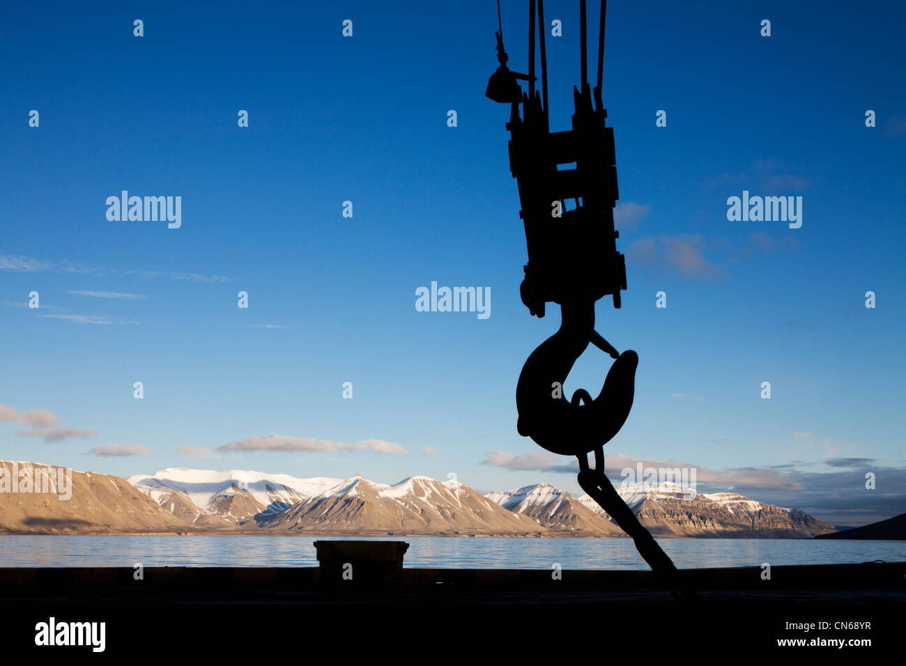 Norway Svalbard Pyramiden Silhouette of crane hook along waterfront at ...