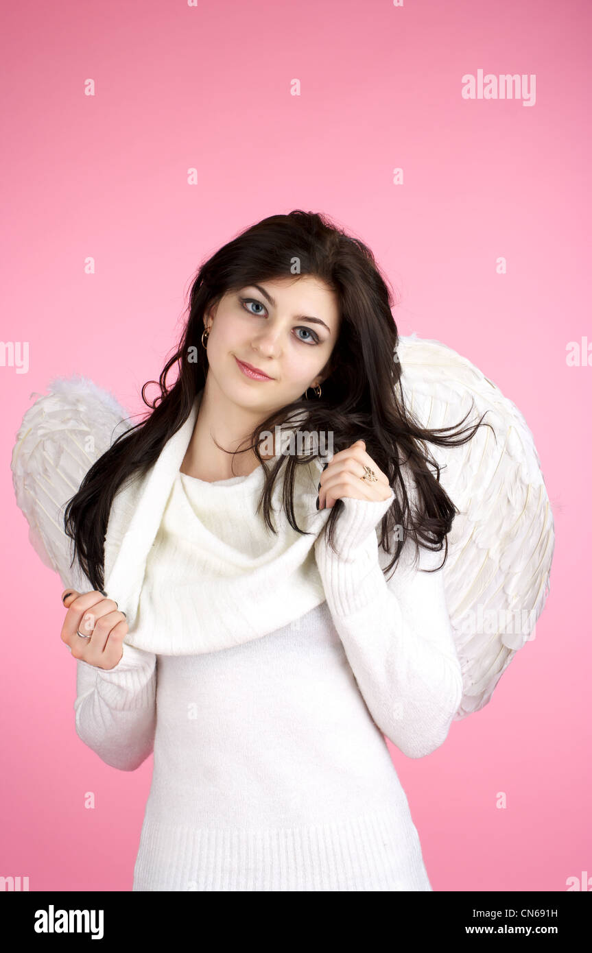 Young beautiful girl in angel suit over pink background Stock Photo - Alamy