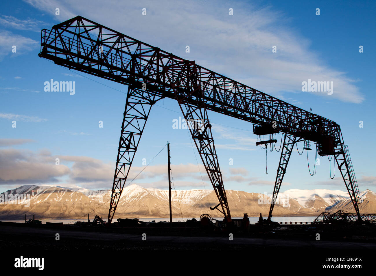 Norway Svalbard Pyramiden Silhouette of loading crane along waterfront ...