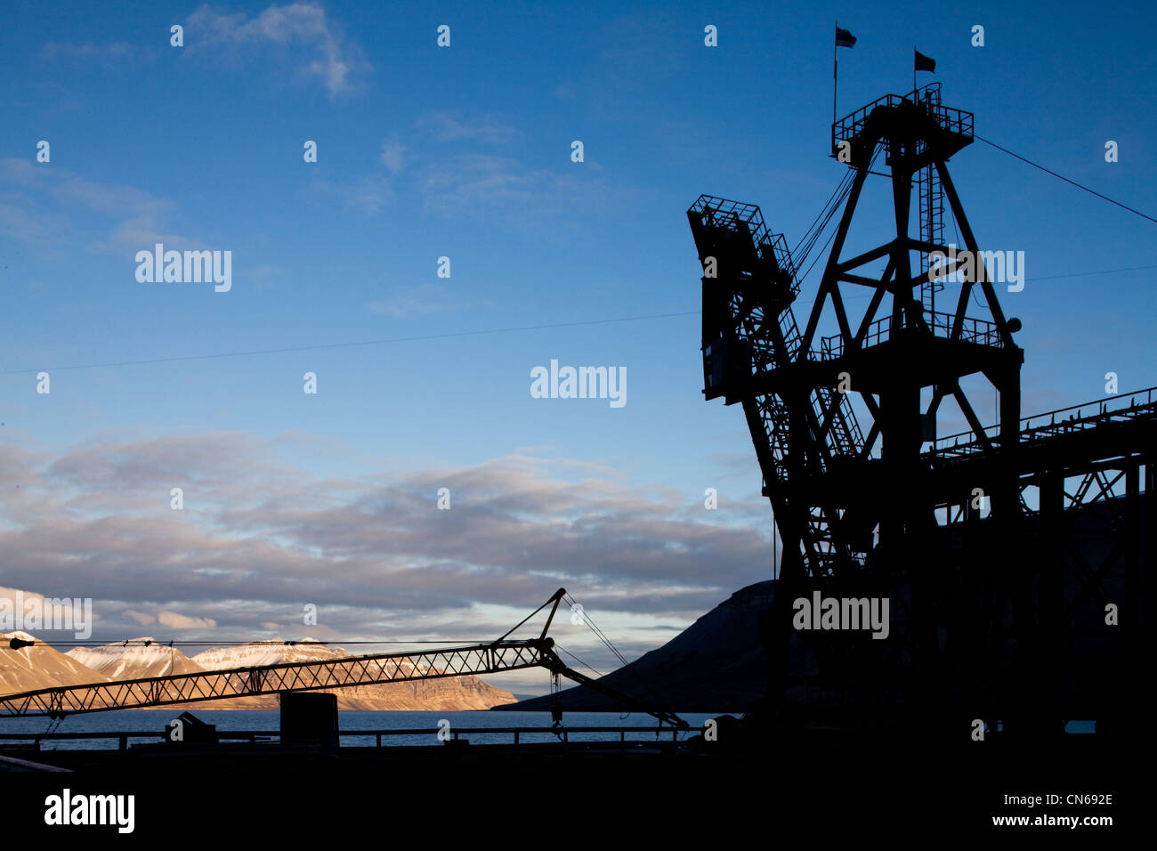 Norway Svalbard Pyramiden Silhouette of loading crane along waterfront ...