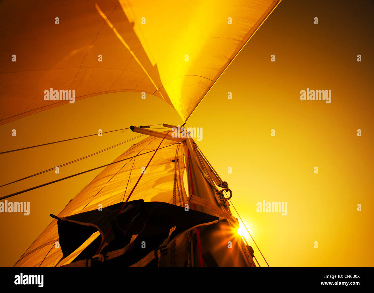 Sail over warm yellow sunset sky, sailboat over natural background ...