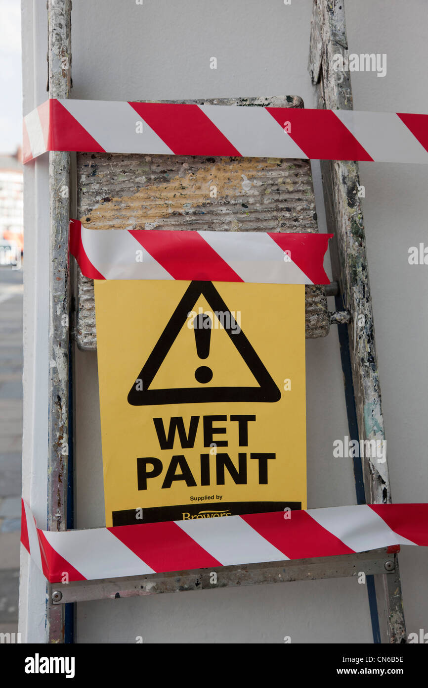 Wet paint sign on a ladder Stock Photo - Alamy