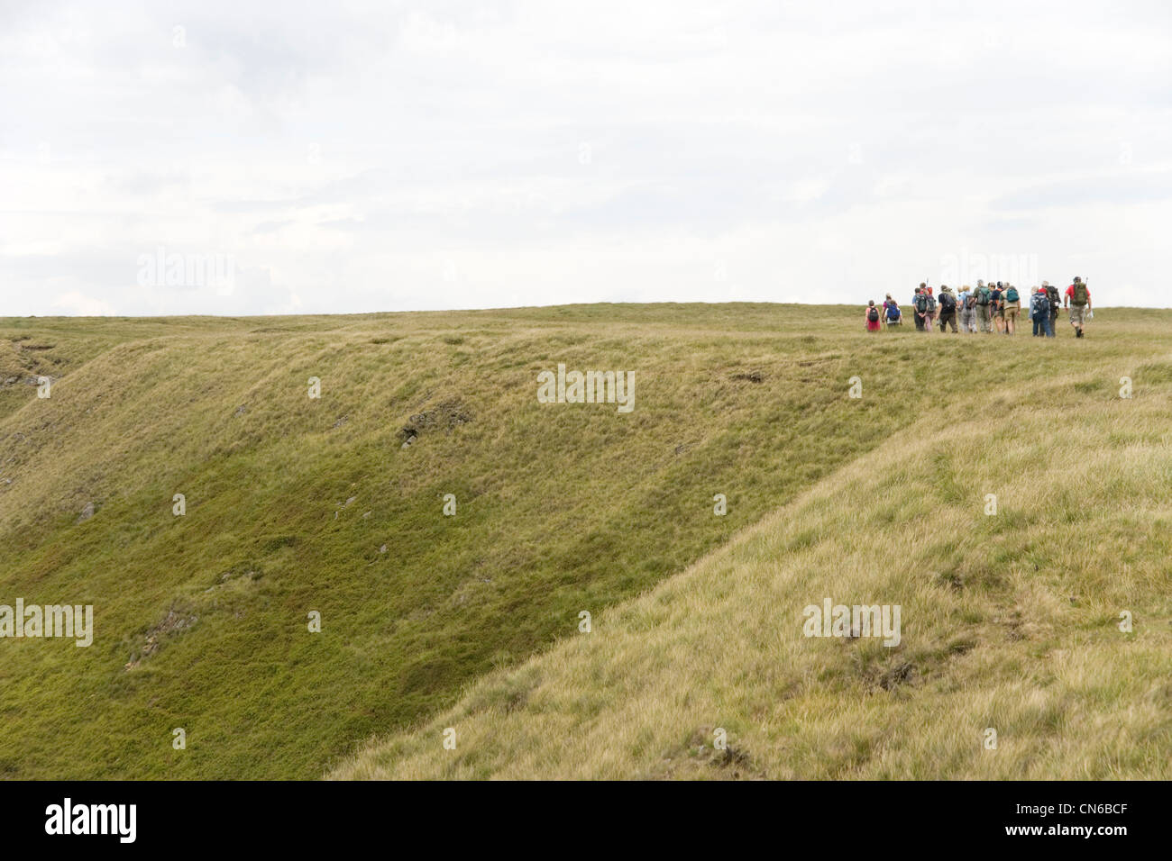 Group of Ramblers walking above Alport Valley by Alport Castles in ...