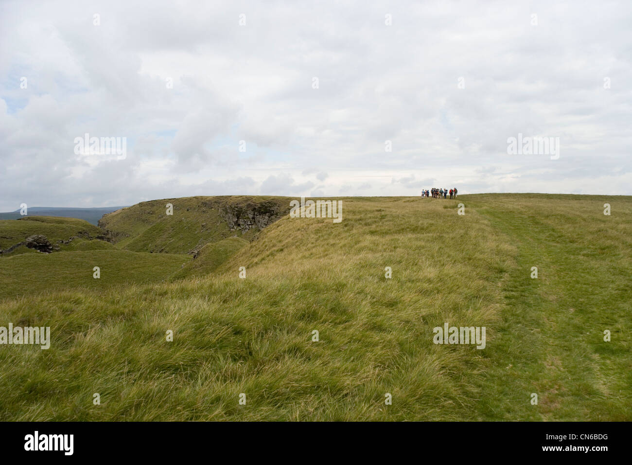 Group of Ramblers walking above Alport Valley by Alport Castles in ...