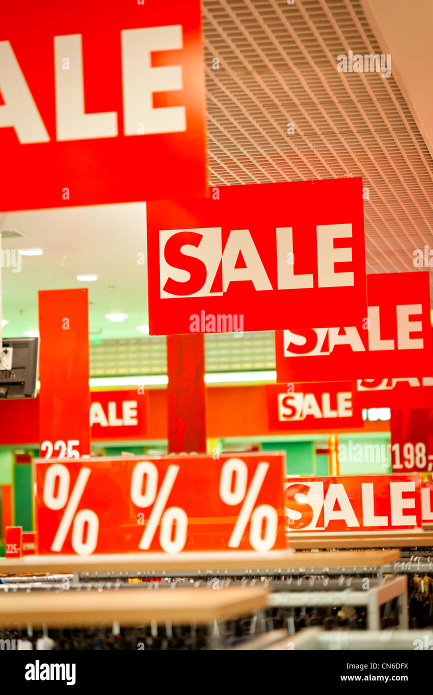 Lots of sale signs in clothing store Stock Photo - Alamy