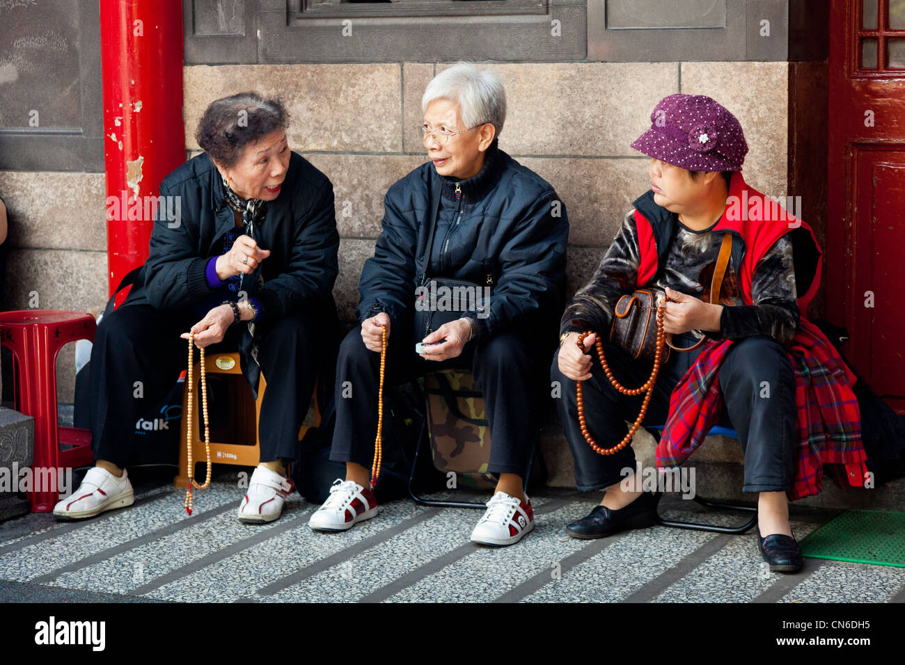 Three old lady worshippers at Longshan or Lungshan Temple Taipei Taiwan ...