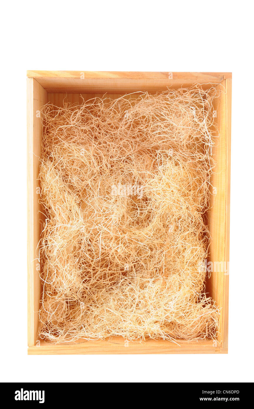 An overhead view of an empty wood shipping crate with straw packing ...