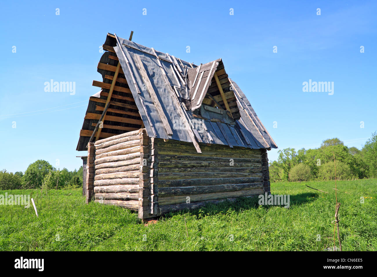 wooden rural house on green field Stock Photo - Alamy