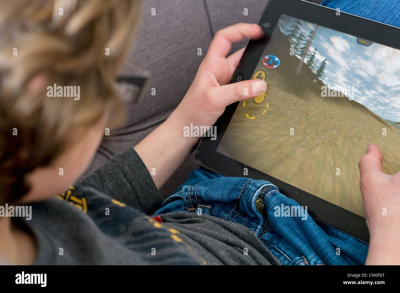 A young boy playing on an iPad 2 Stock Photo - Alamy