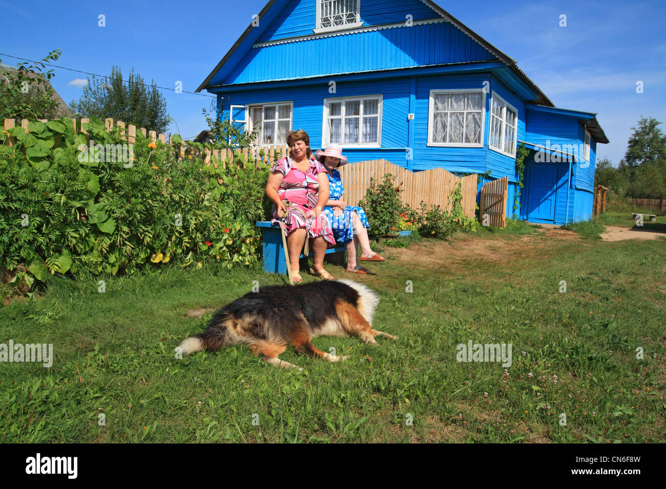 two womens with dog in rural courtyard Stock Photo - Alamy