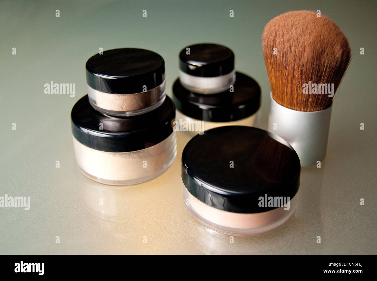 Mineral makeup pots and brush Stock Photo - Alamy