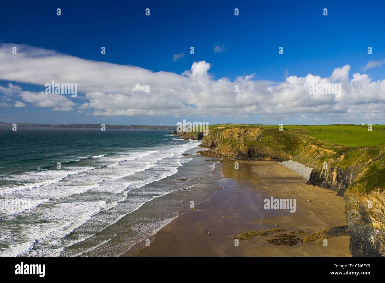 Two people walk on almost deserted DruidstoneBeach near Broad Haven ...