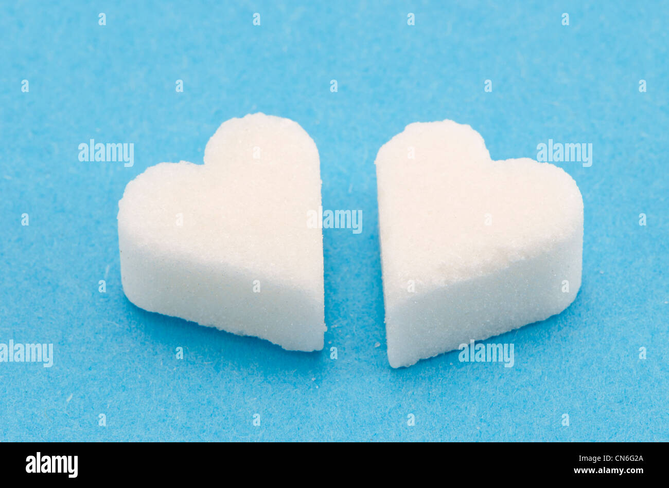 two white sugar hearts on azure background Stock Photo - Alamy
