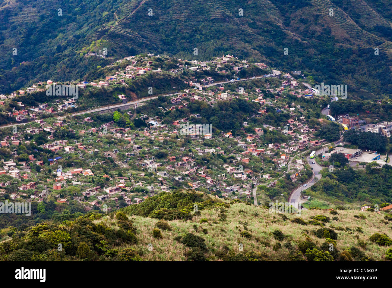 Taiwanese cemetery on hillside in the shadow of Keelung Mountain near ...