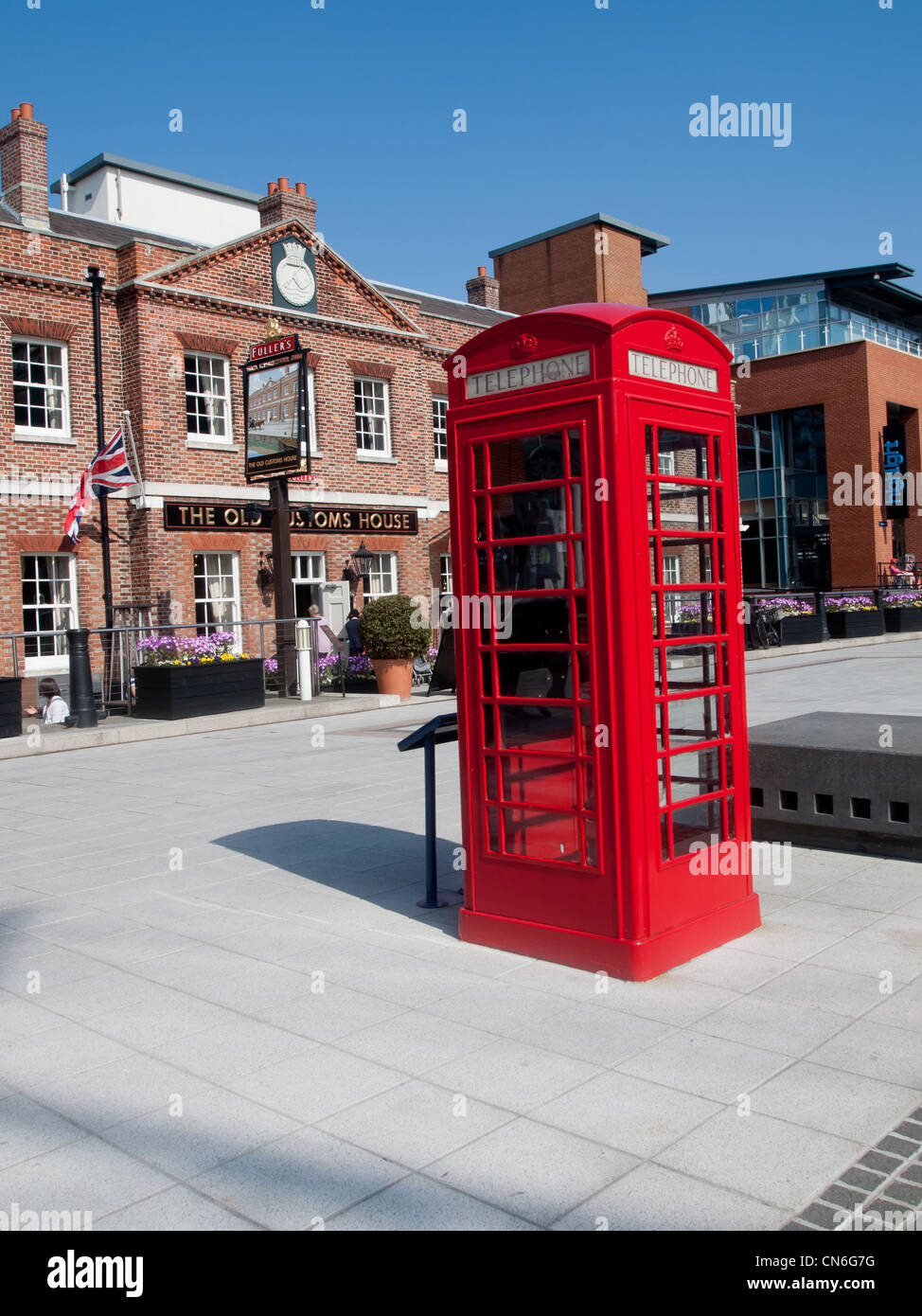 A red telephone box in front a public house in England Stock Photo - Alamy
