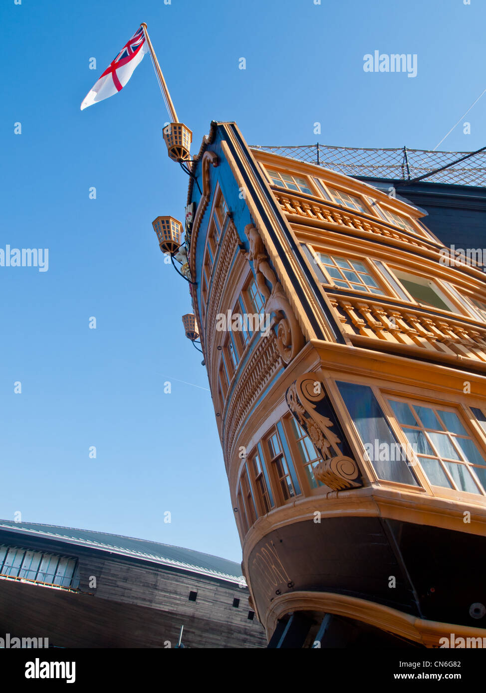 The stern of HMS Victory with the white ensign flying from the quarter ...