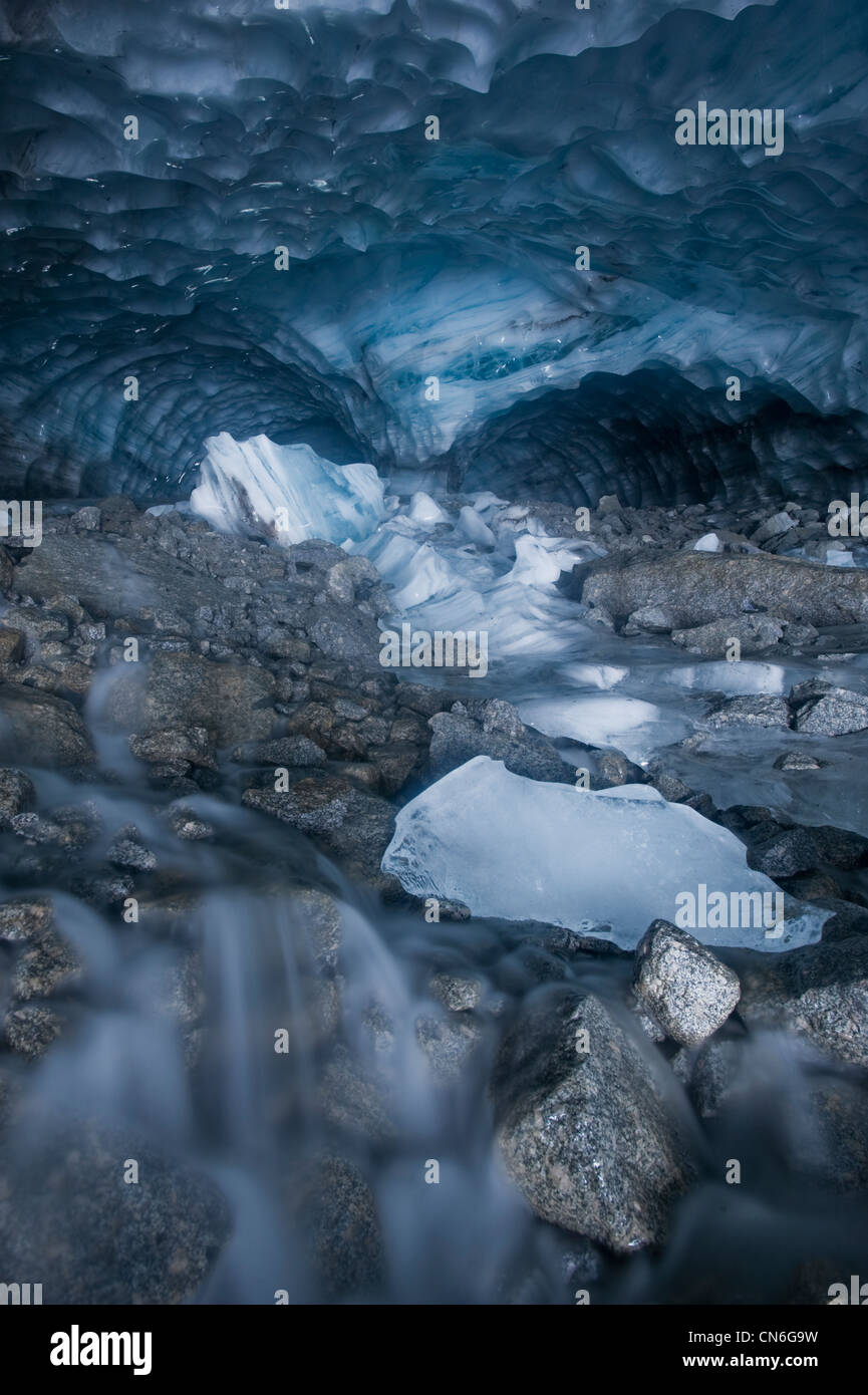 Glacial creek flowing from blue ice cave in Britnell Glacier, Nahanni ...