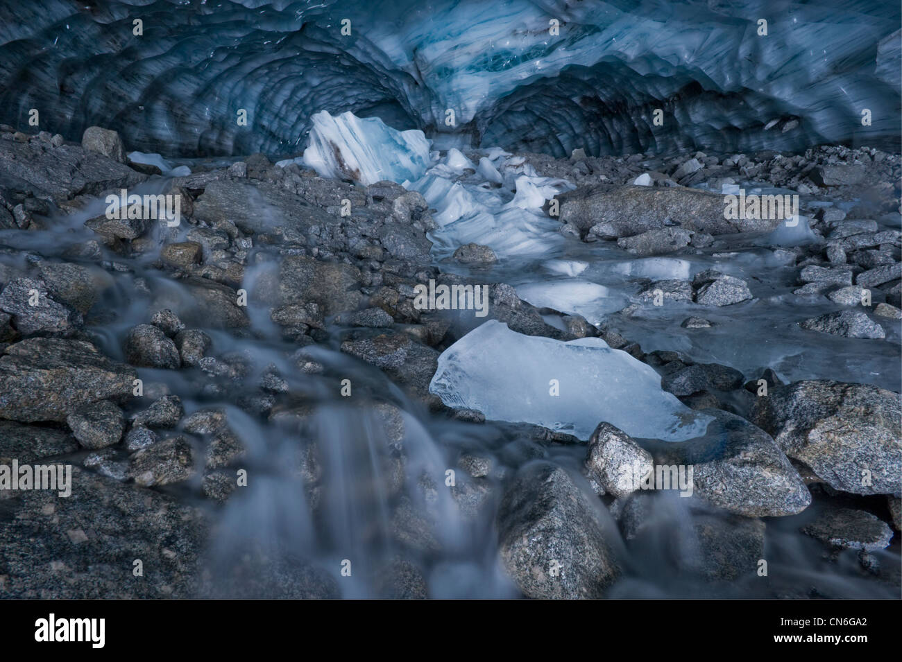 Glacial creek flowing from blue ice cave in Britnell Glacier, Nahanni ...