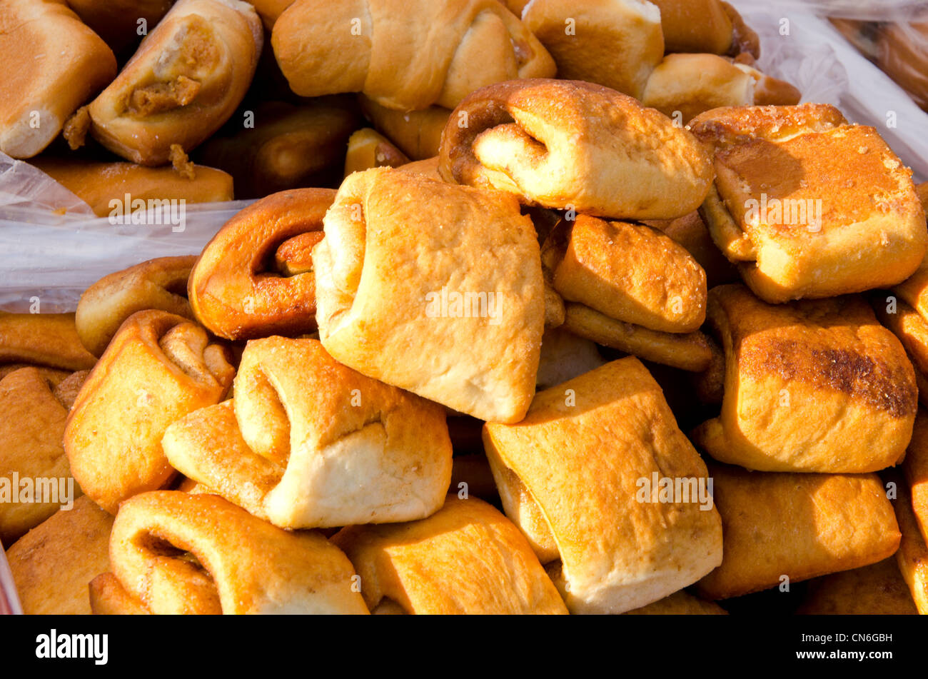 Baked homemade sweet buns with cinnamon sold in outdoor street market ...