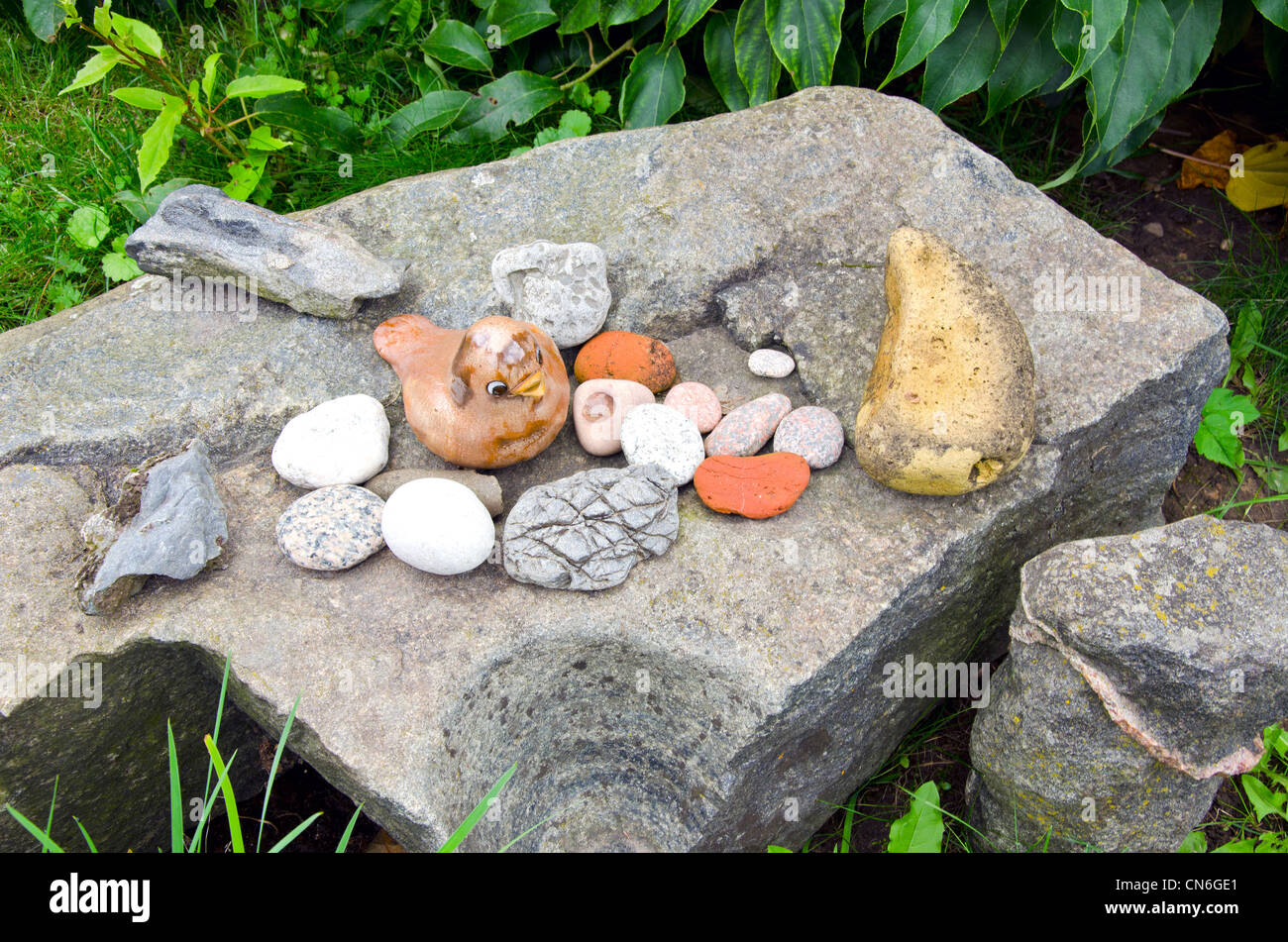 Ancient vintage retro rock stone in garden and decorative objects ...