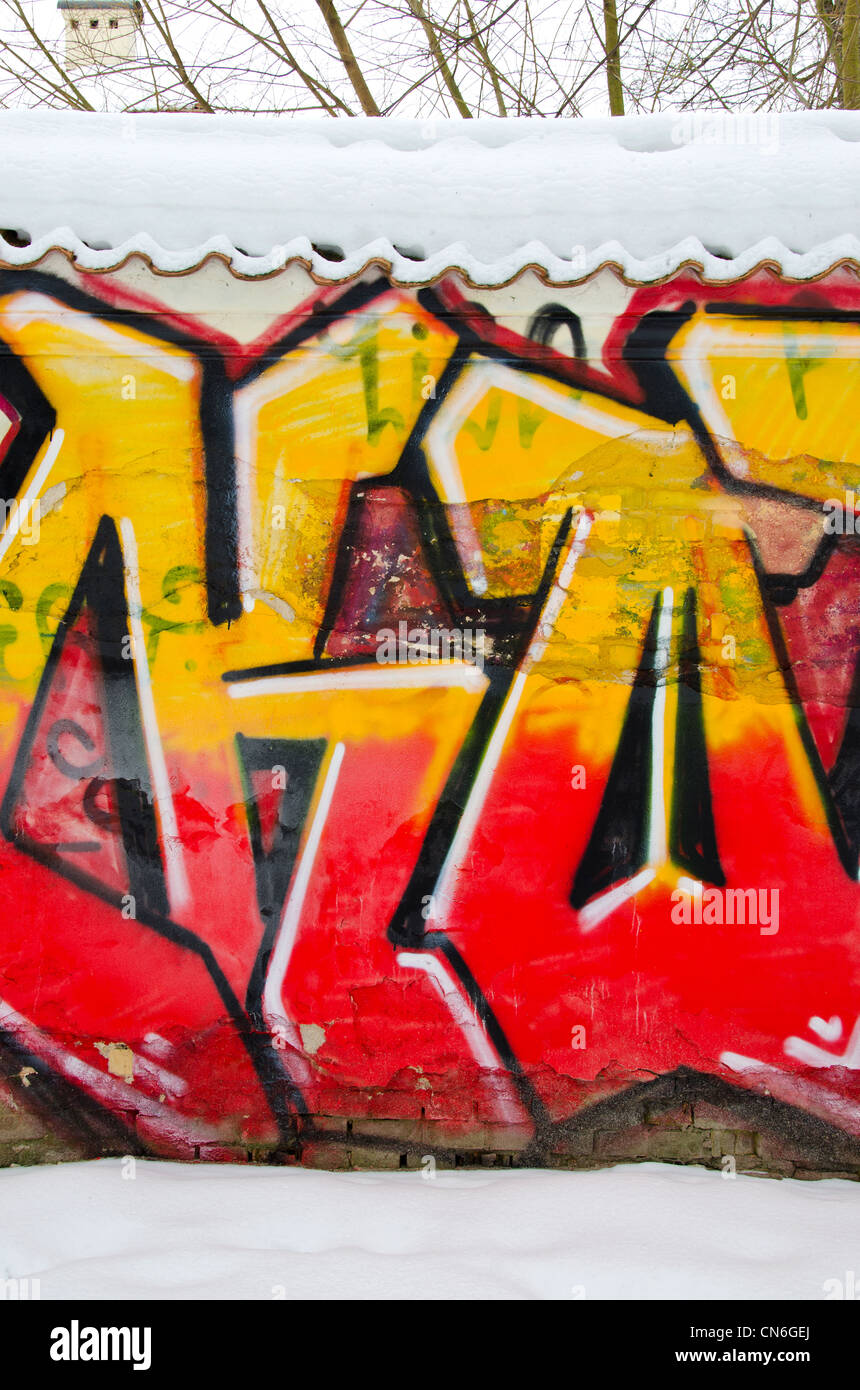 Graffiti on ancient grunge vintage house wall covered with snow in ...