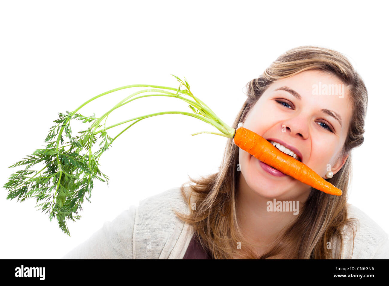 Young beautiful funny woman eating fresh carrot, isolated on white ...