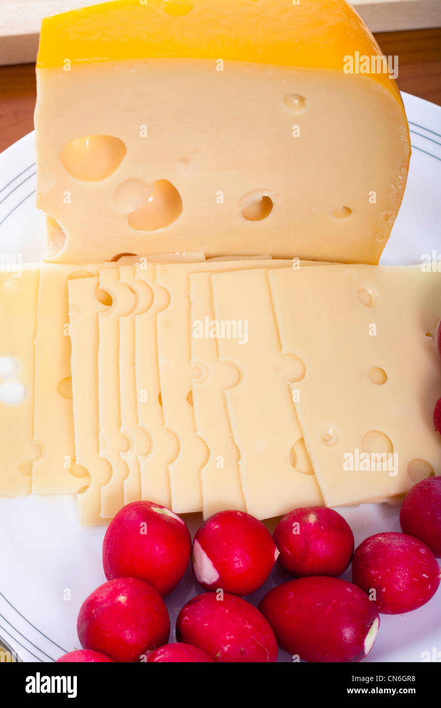 Detail of dish with Emmenthal cheese and fresh radishes Stock Photo - Alamy