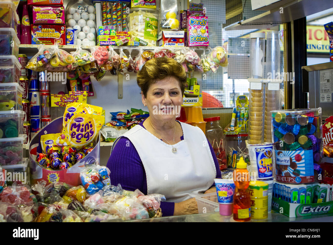 Lady standing in a sweet stall in an inside market in Warrington ...