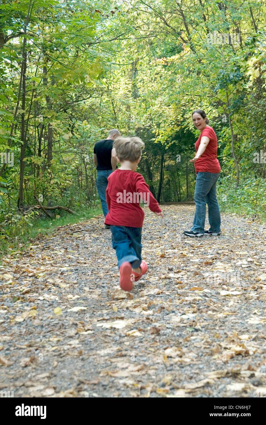 Little Boy Running Towards his Parents on a Path in Autumn, The ...