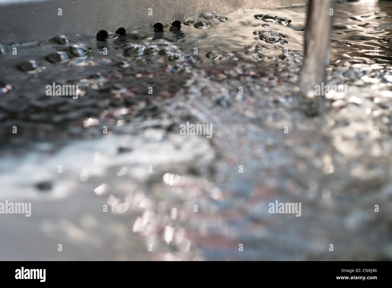 Water in sink reaching overspilling level Stock Photo - Alamy