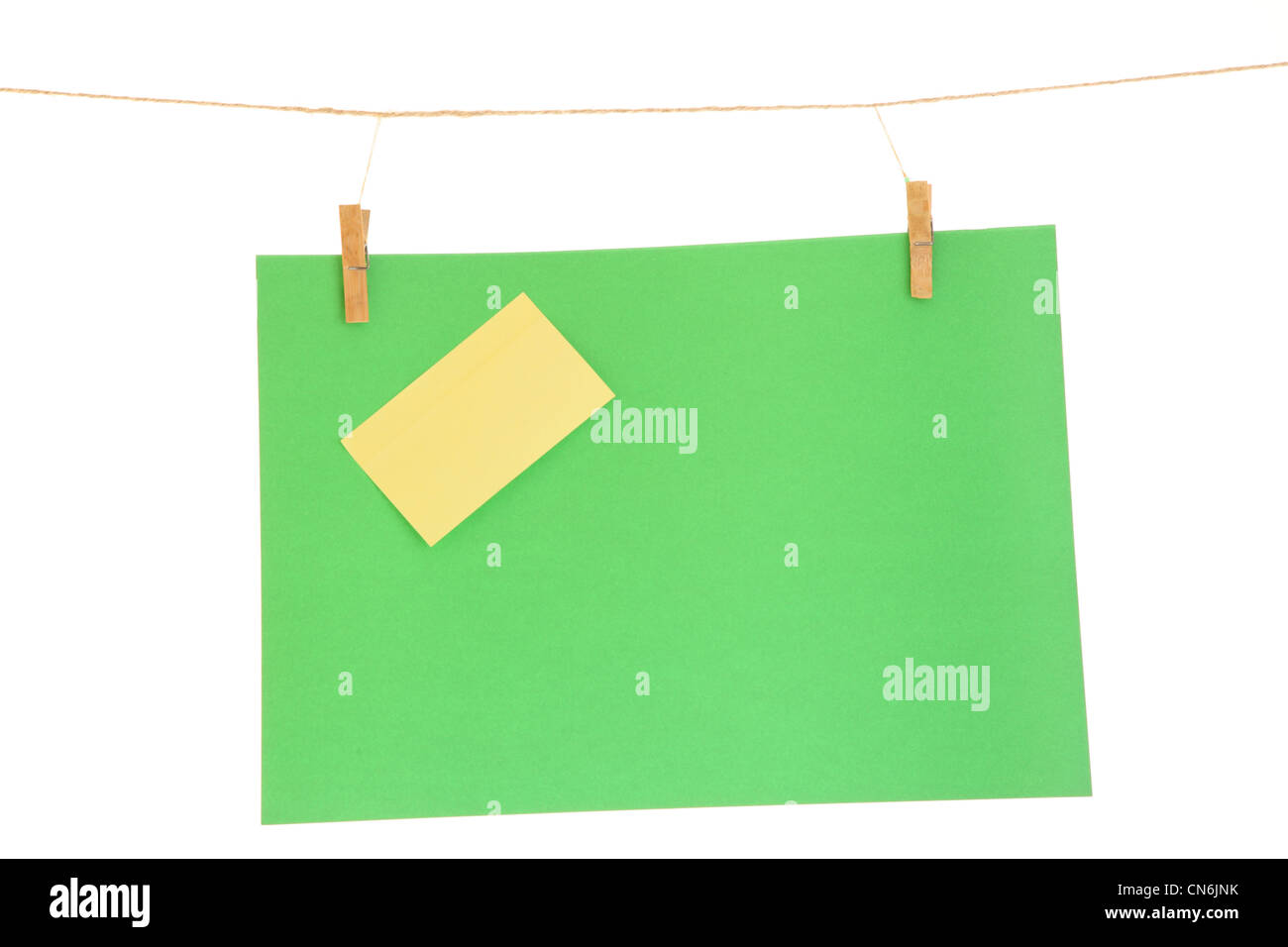 green blank paper sheet on a clothes line. Isolated on white background ...