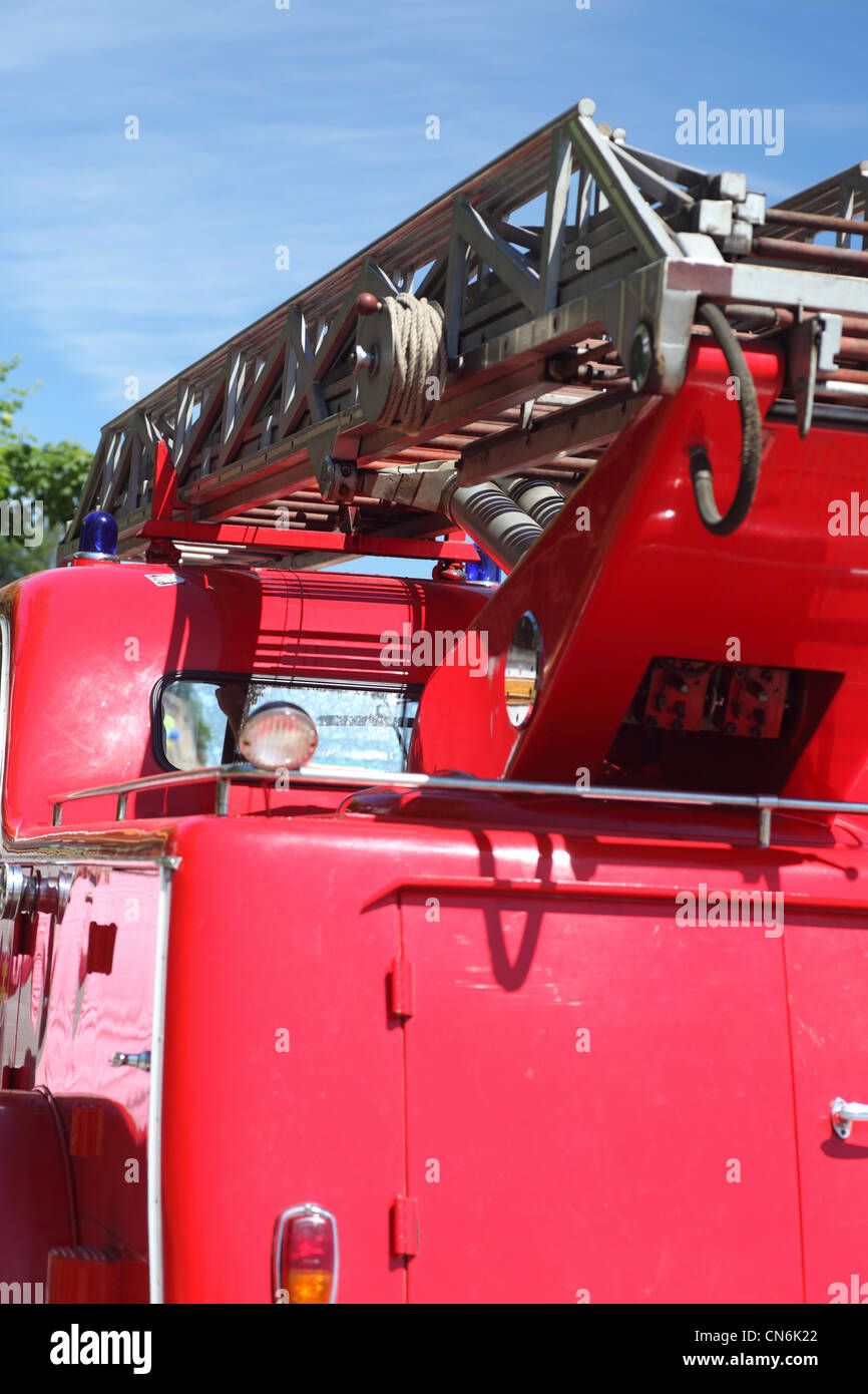 Ladder of a fire truck on the blue sky, emergency light on firetruck ...