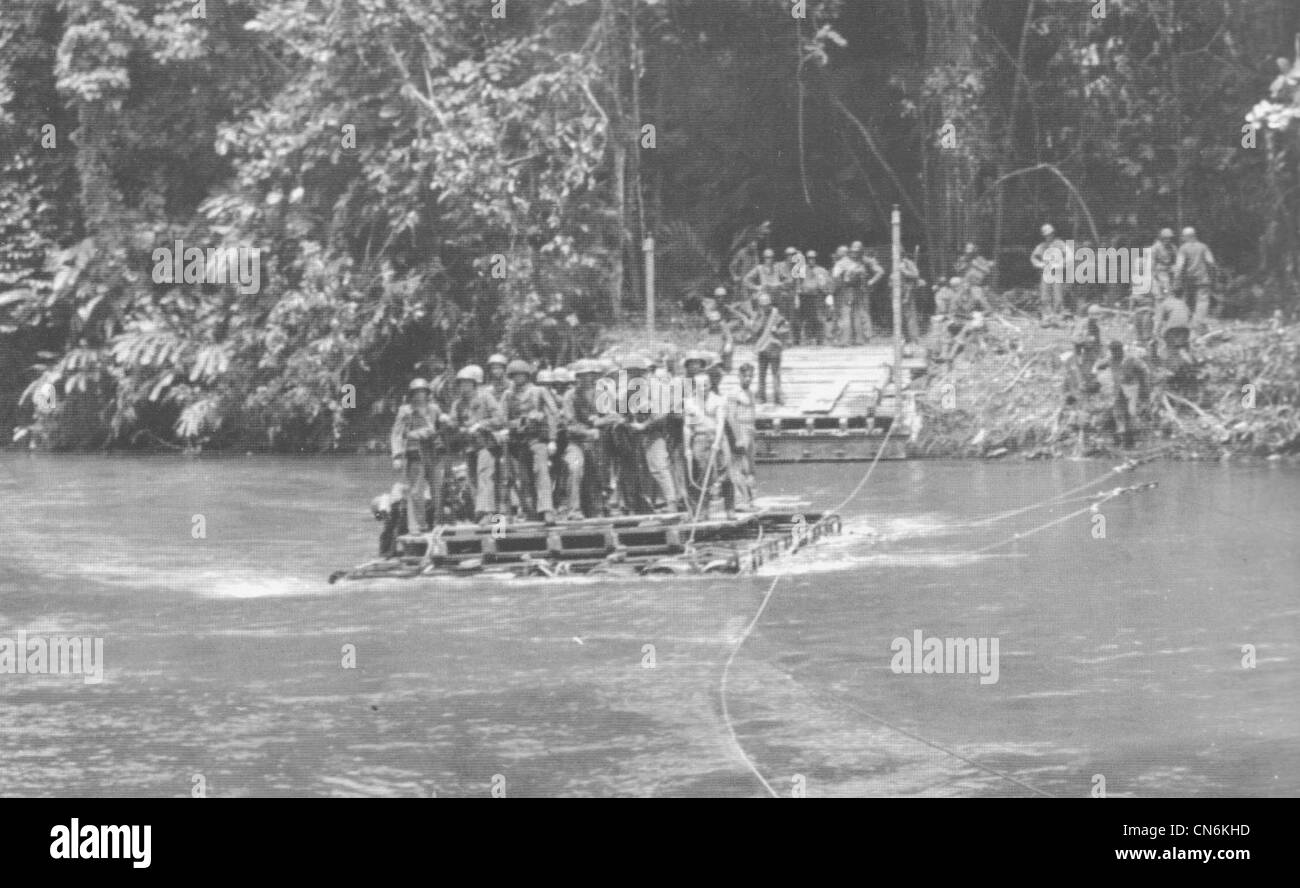 U.S. Marines cross the Matanikau River on Guadalcanal on a raft ferry ...