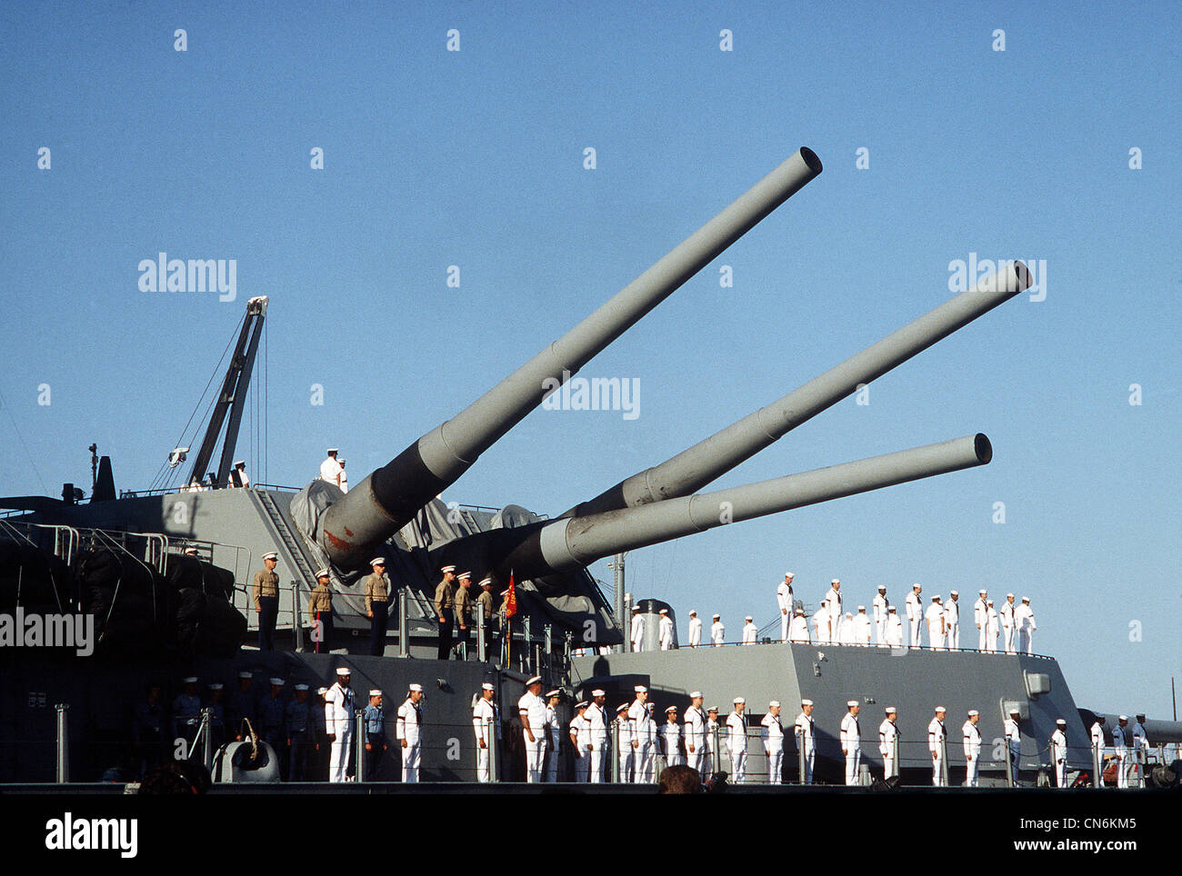 Crew members man the rails aboard the battleship USS Iowa (BB-61) as ...