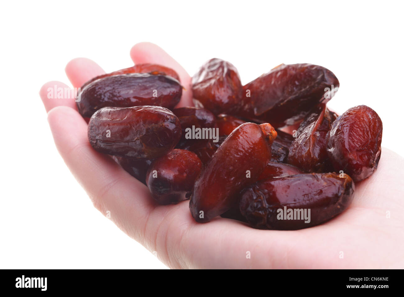 Dried date fruits in hand isolated on white background Stock Photo - Alamy