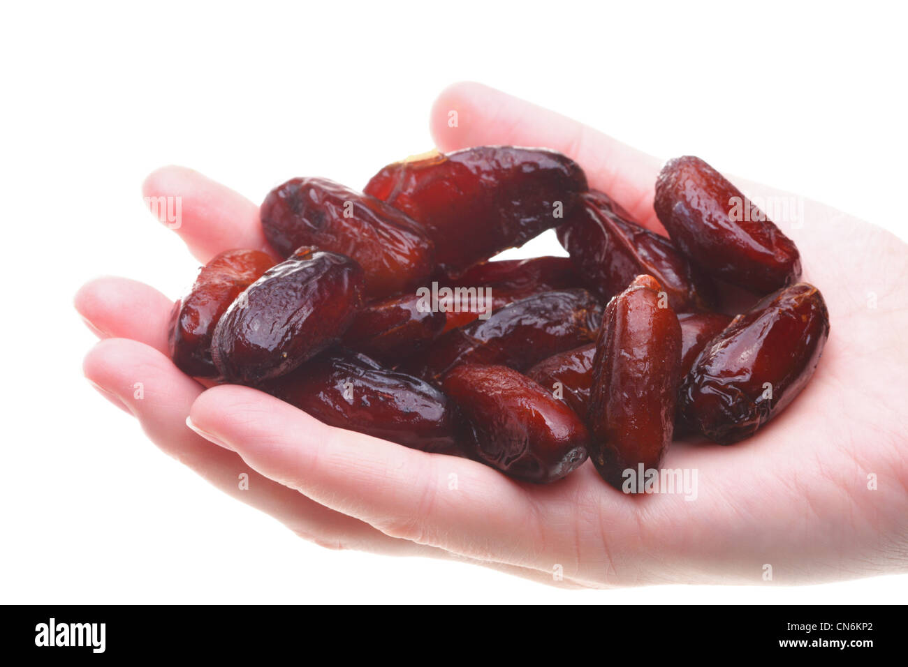 Dried date fruits in hand isolated on white background Stock Photo - Alamy