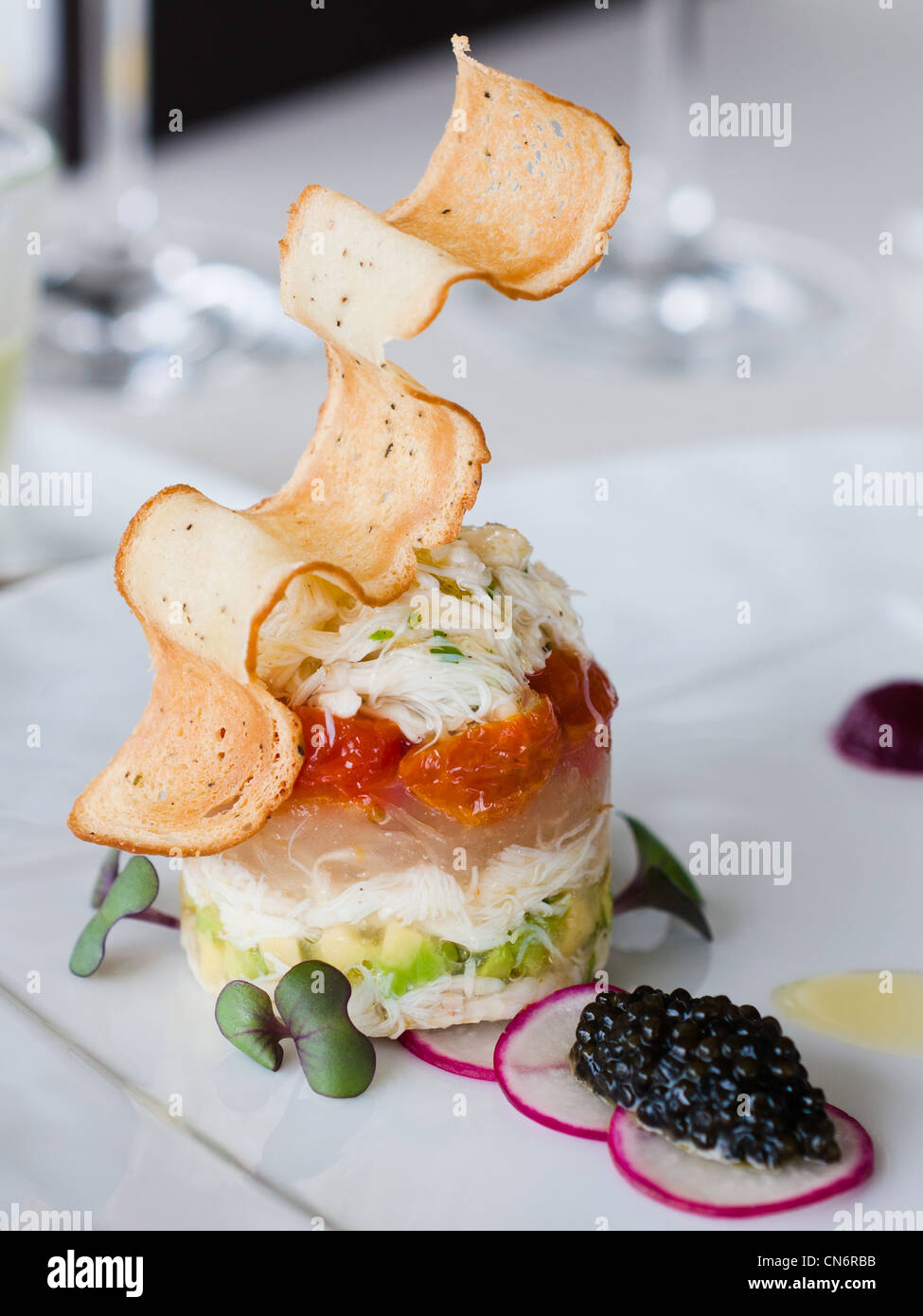 Appetizer at luxury restaurant made with crab, salmon and vegetables ...
