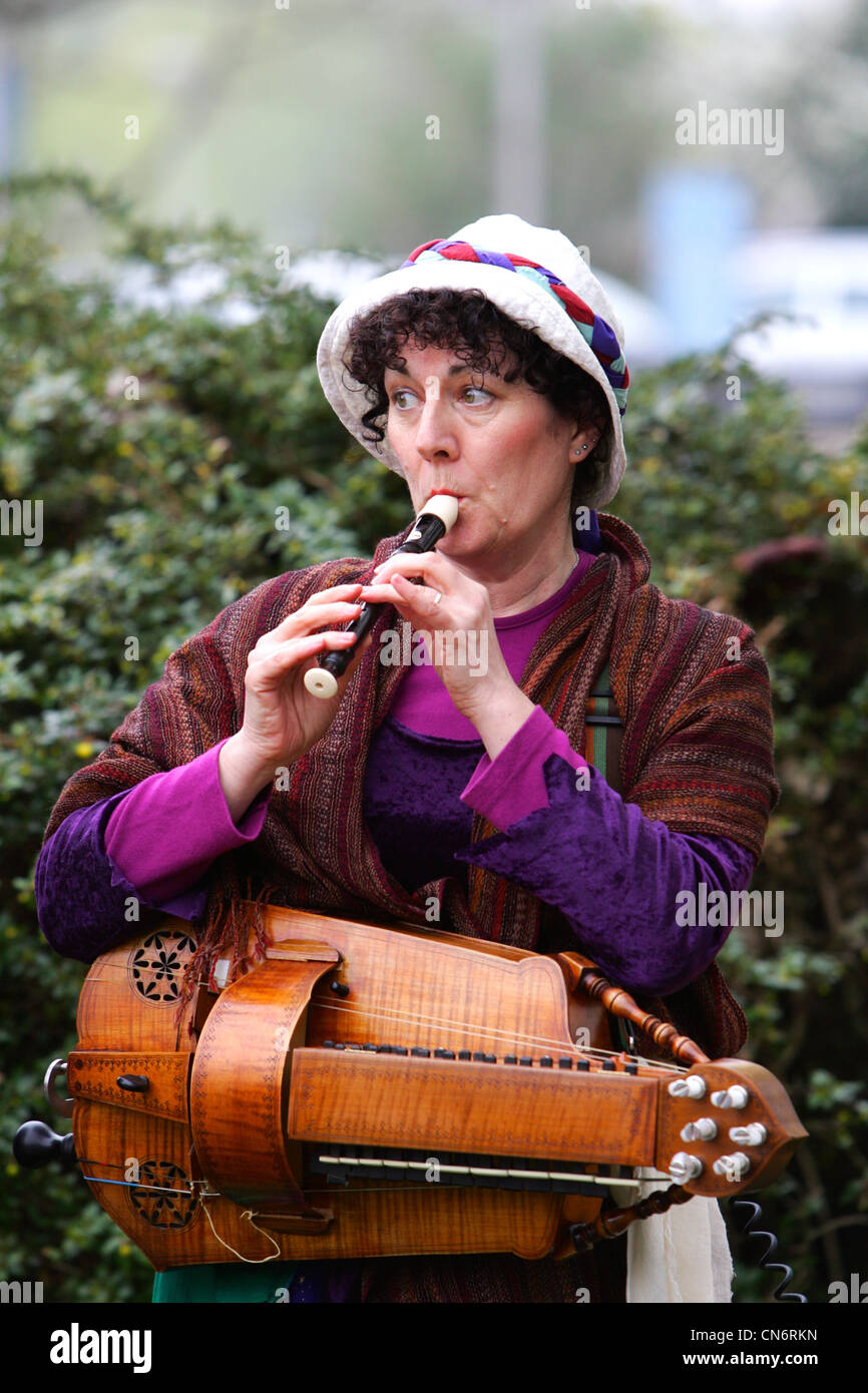 Lady playing a recorder with a hurdy gurdy Stock Photo - Alamy