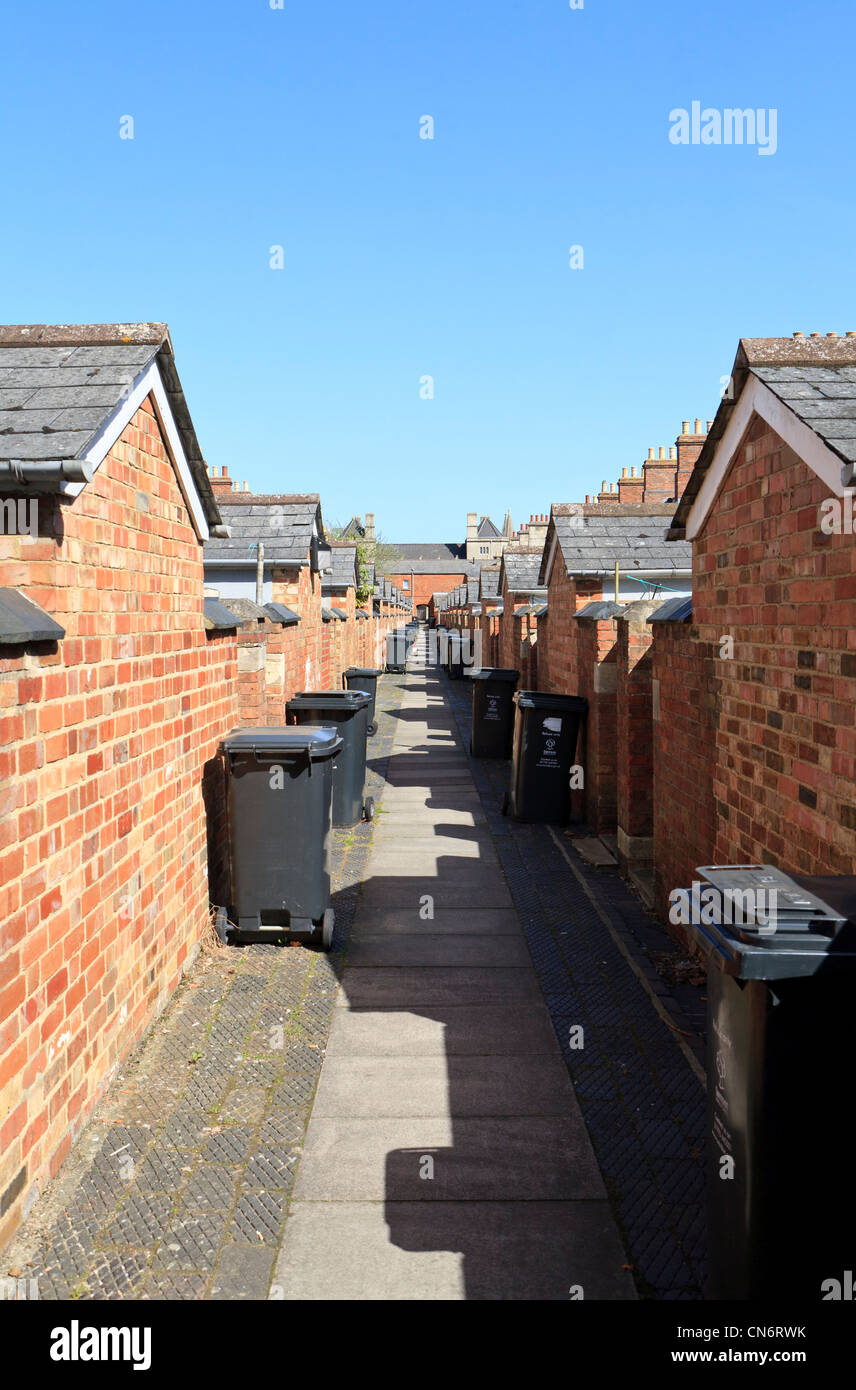 Alley between houses with wheelie bins UK Stock Photo - Alamy