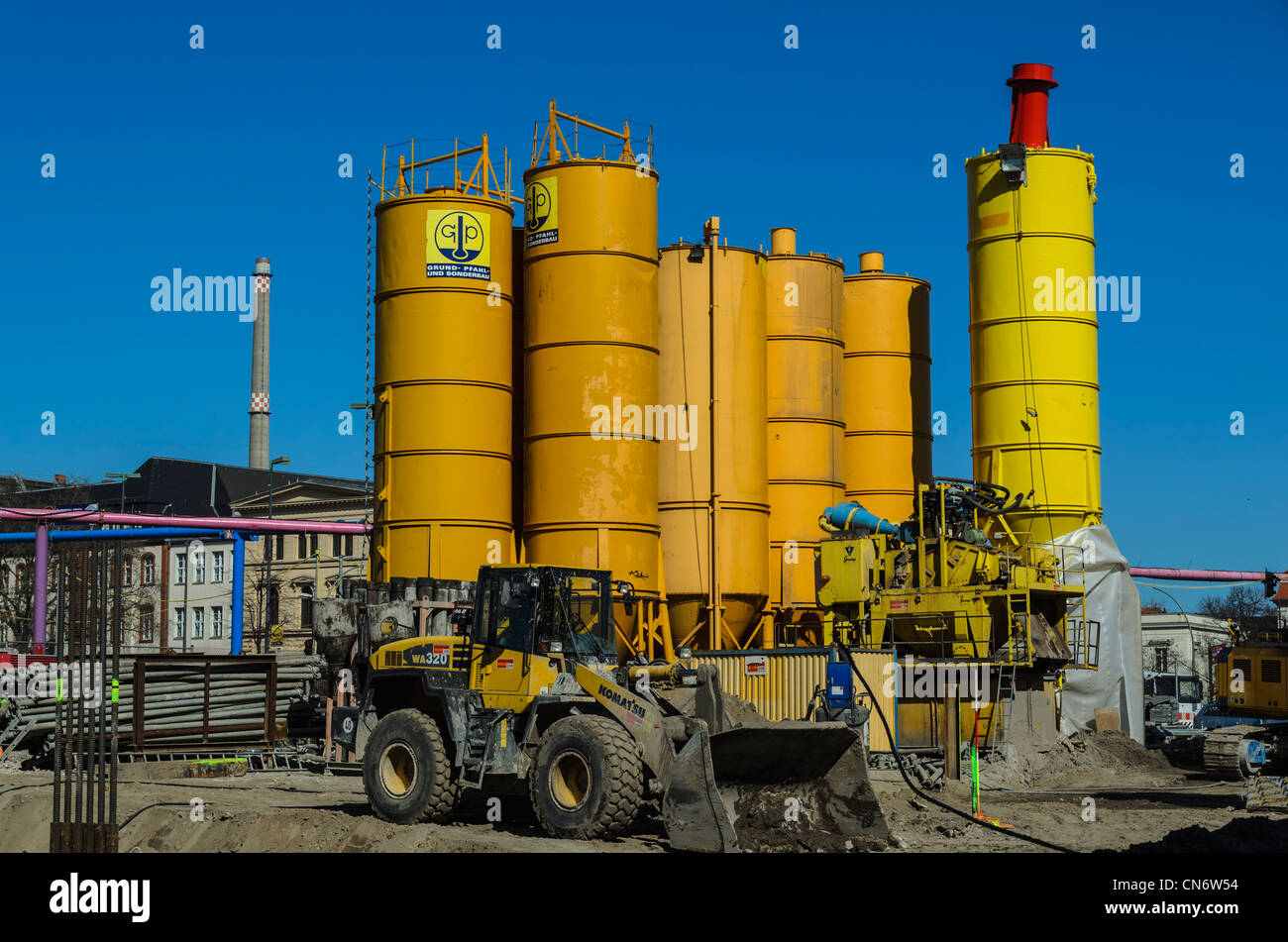 Yellow cement containers at construction site Stock Photo - Alamy