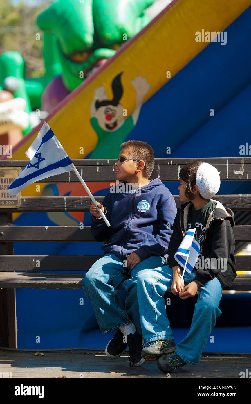 Two young jewish boys holding and waving the Israeli flag during the ...