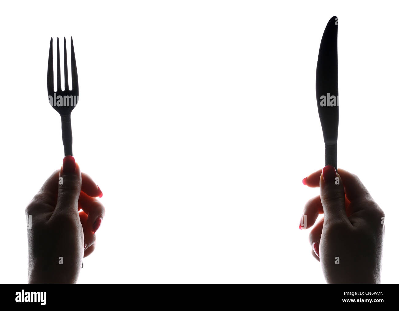 Woman's hands holding knife and fork, isolated on white background ...
