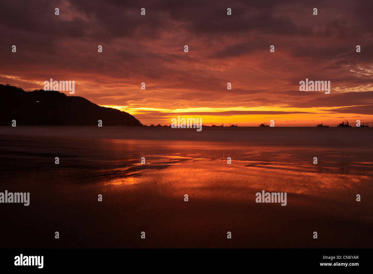 Sunset at the fishing harbor Stock Photo - Alamy