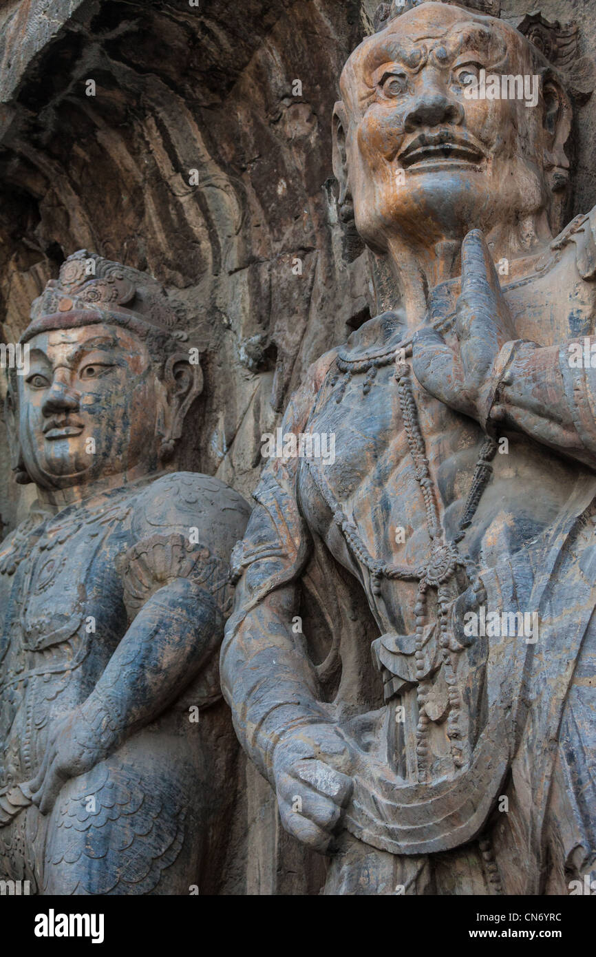 Statues of Buddha's disciples in the Fengxian caves at the Longmen ...