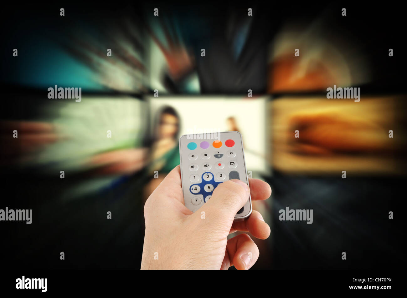 Man using a remote control and changing TV channels Stock Photo - Alamy