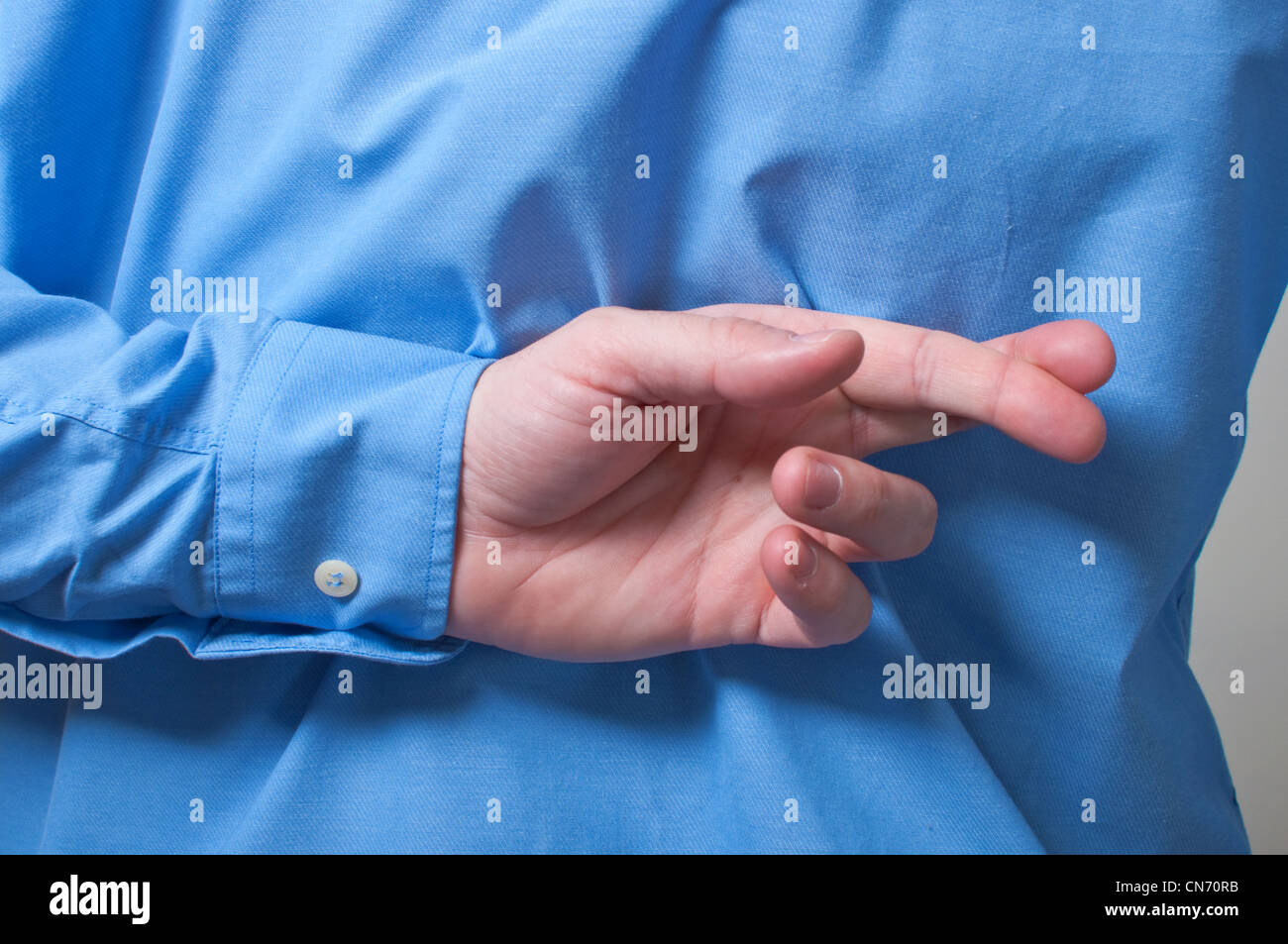 Businessman fingers crossed behind back hi-res stock photography and ...